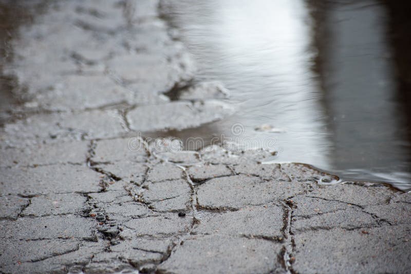 Asphalt in the Cracks among the Puddles Stock Photo - Image of abstract ...