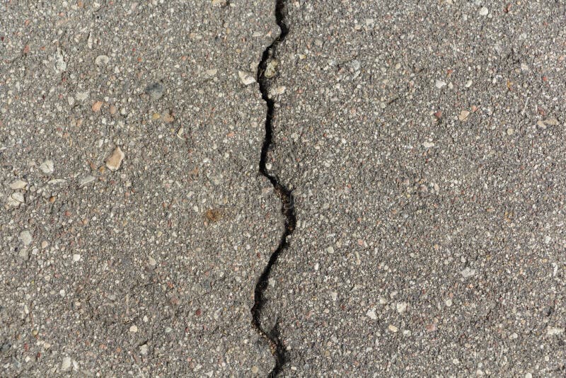 Asphalt with Cracks Radiating Across the Surface. Stock Image - Image ...