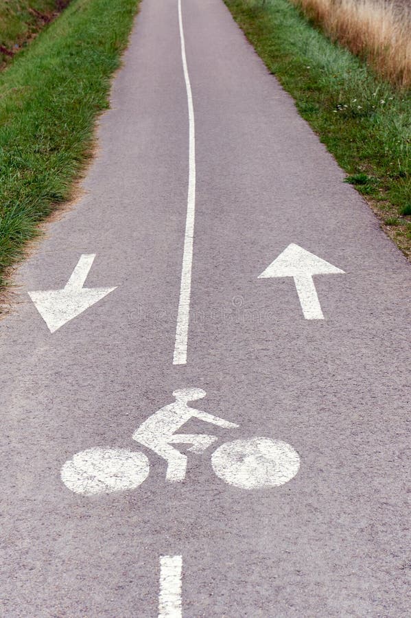 Asphalt Cycle Path with Central Markings and Direction Arrows in a ...