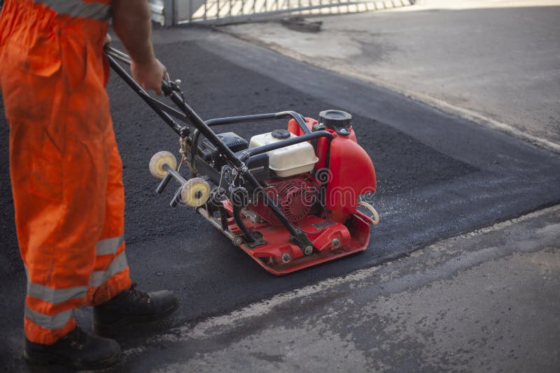 Asphalt Laying. Leveling the Road Stock Photo - Image of infrastructure ...