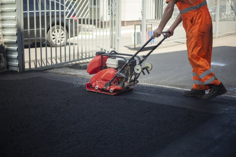 Asphalt Laying. Leveling the Road Stock Image - Image of leveling ...