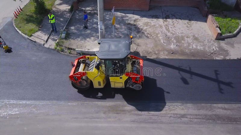 Asphalt Laying. Road Building Asphalt Paver is Laying a New Layer of ...