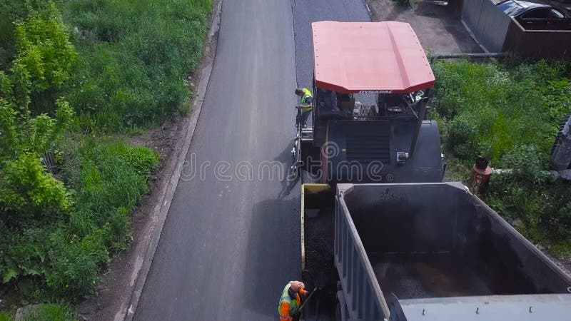 Asphalt Laying. Road Building Asphalt Paver is Laying a New Layer of ...