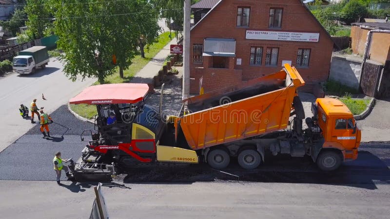 Asphalt Laying. Road Building Asphalt Paver is Laying a New Layer of ...
