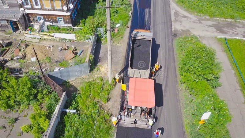 Asphalt Laying. Road Building Asphalt Paver is Laying a New Layer of ...