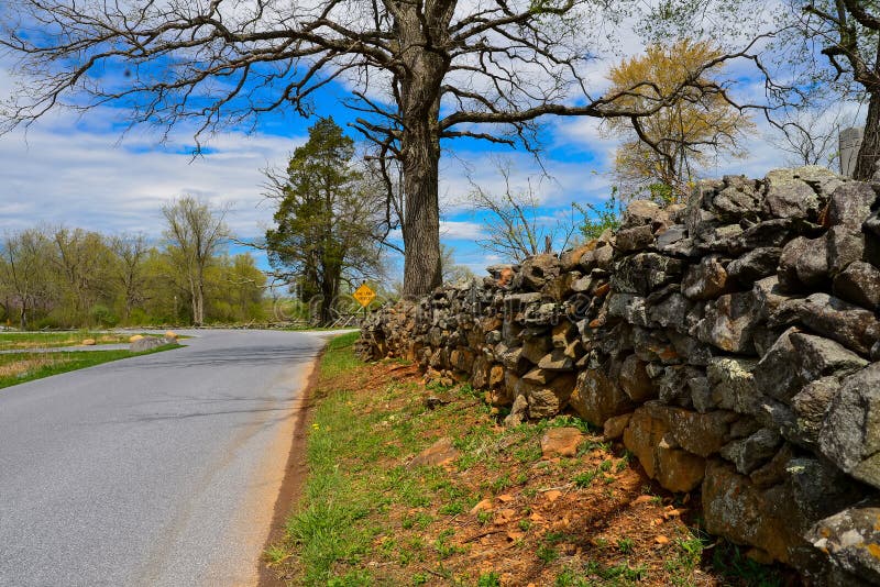 Asphalt Path in the Park Along a Stone Wall Stock Photo - Image of ...