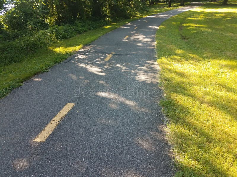 Asphalt Biking Trail with Trees and a Shortcut Path through the Grass ...