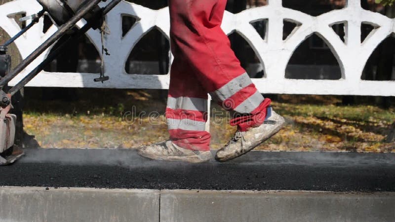 Asphalt Paver or Asphalt Paver on a Construction Site. a Worker Sits in ...