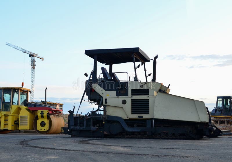 Asphalt Paver Machine and Road Roller Working at Construction Site ...