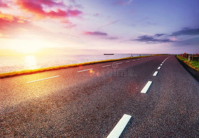 Asphalt Road Along the Sea at Sunset Stock Image - Image of lane ...