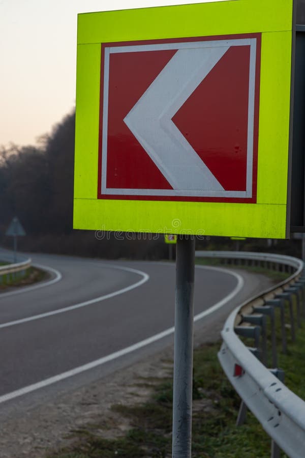 Asphalt Road with Bright Traffic Signs in Situ of the Sharp Left Turn ...
