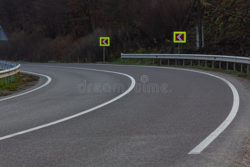 Asphalt Road with Bright Traffic Signs in Situ of the Sharp Left Turn ...