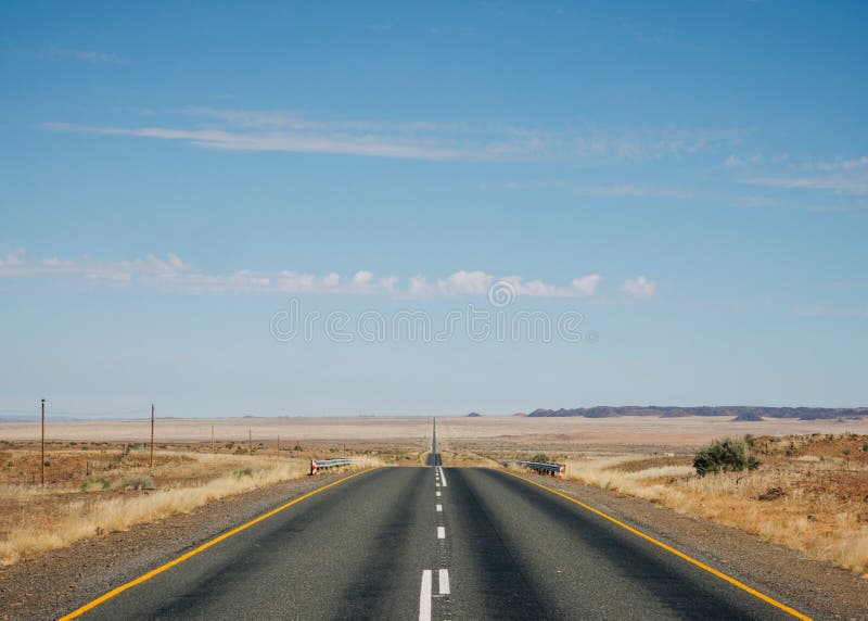 Asphalt Road through Brown Fields Under Blue Sky Stock Photo - Image of ...