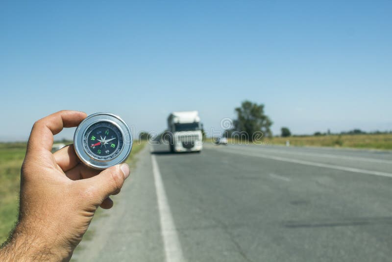 Asphalt road and compass stock image. Image of hand - 214942283