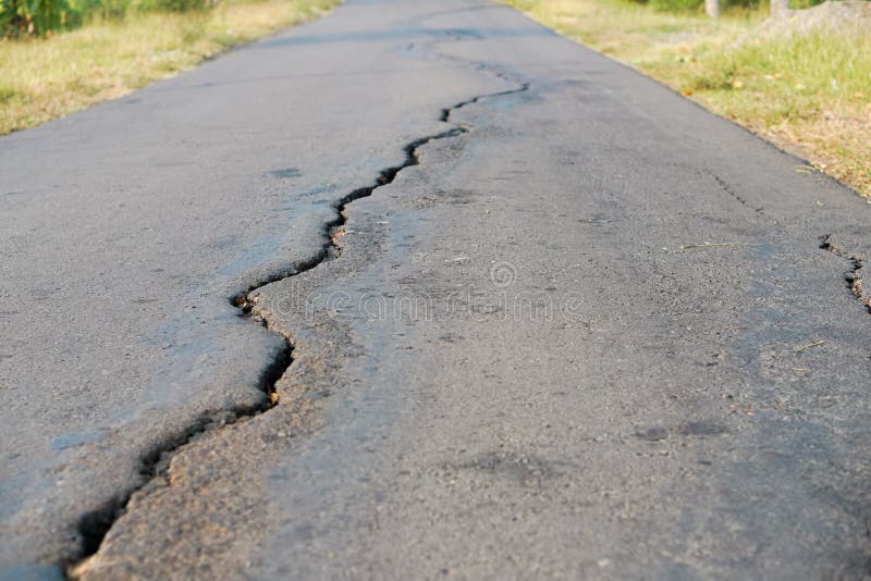 Asphalt Road Cracked Due To Moving Ground. Earthquake Stock Photo ...