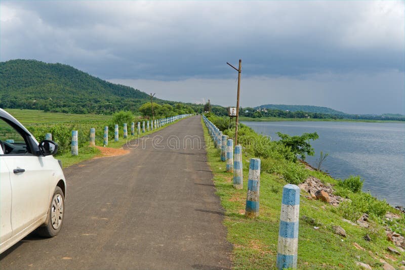 Asphalt Road beside Lake with Boundary Pillars Stock Image - Image of ...