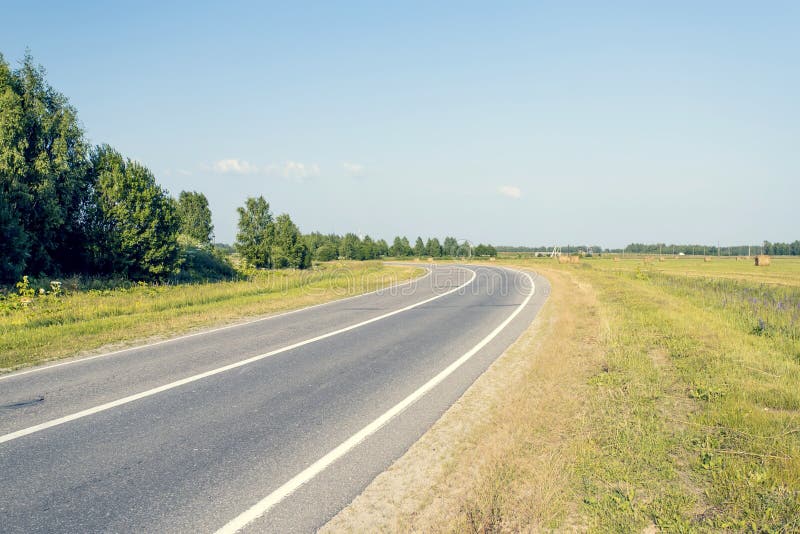 Asphalt Road Leading into the Distance Around the Bend Stock Image ...