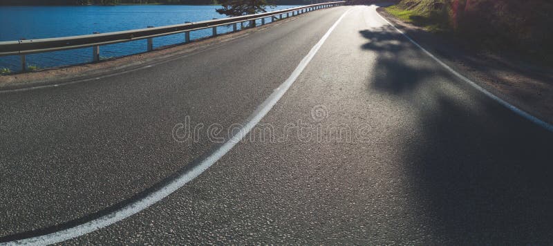 Asphalt Road Near the Lake. Low Angle Stock Image - Image of drive ...