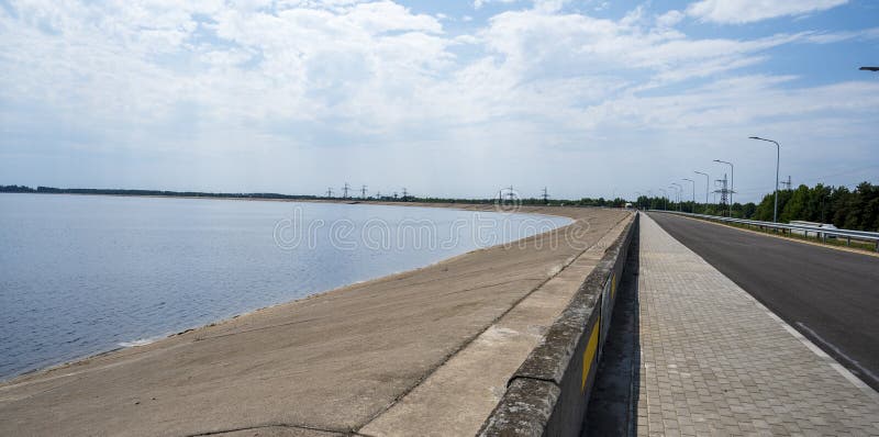 Asphalt Road Next To the Concrete Bank of the Dam Stock Image - Image ...