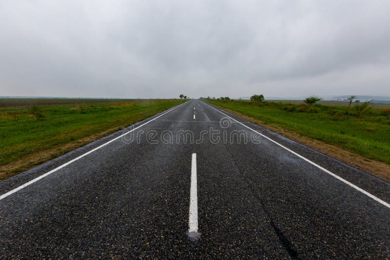 Asphalt Road Receding into the Distance among Green Fields Stock Photo ...