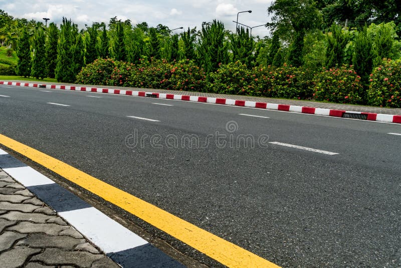 Asphalt Road with Red and White Concrete Curb Stock Photo - Image of ...