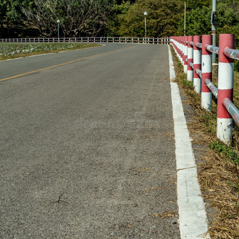 Asphalt Road with Red and White Fence Stock Photo - Image of country ...