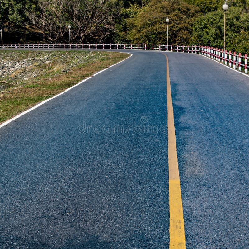 Asphalt Road with Red and White Fence Stock Image - Image of fence ...