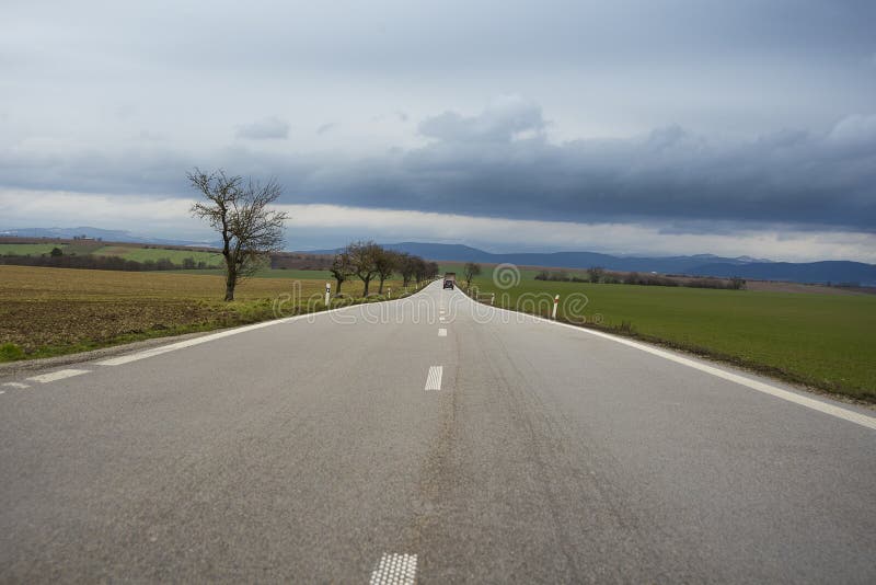 Asphalt Road with a Sky and Cars in Distance Stock Image - Image of ...