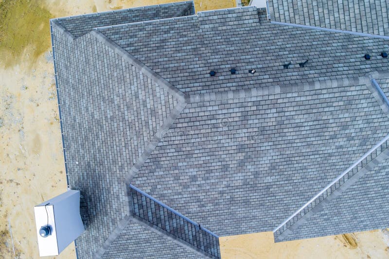 On Newly Constructed Home, Overlapping Asphalt Shingles are Seen on a ...