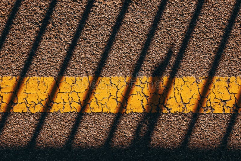 Asphalt Sidewalk Surface with Worn Yellow Line and Striped Shadow ...