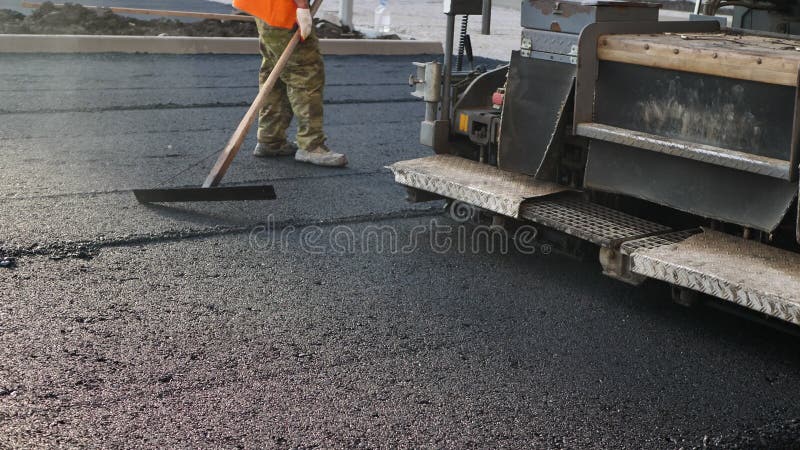 An Asphalt Spreader or an Asphalt Paver Machine on a Road Construction ...
