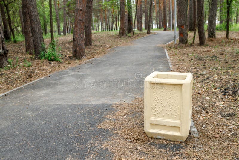 An Asphalted Path for Walking in the Park, a Litter Bin is Installed on ...