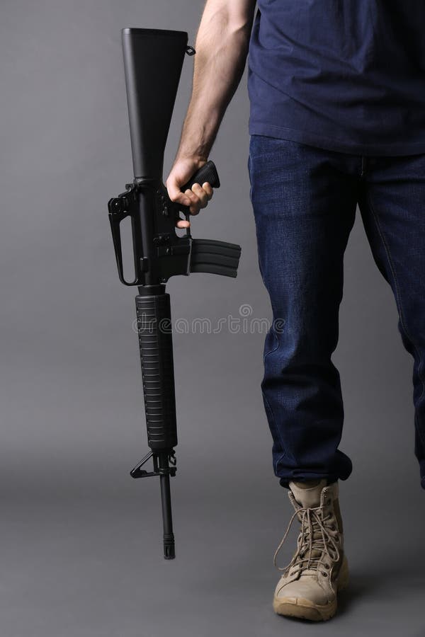 Assault Gun. Man Holding Rifle on Dark Background, Closeup Stock Photo ... Assault Gun. Man Holding Rifle on Dark Background, Closeup Stock Photo ...