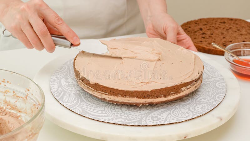 Assembling the Cake. Woman Hands Topping Part of the Cake with ...