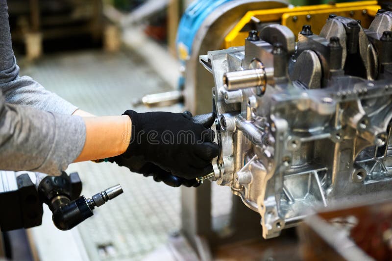 Assembling Car Engine by Worker Hand in Workshop Closeup Stock Photo ...