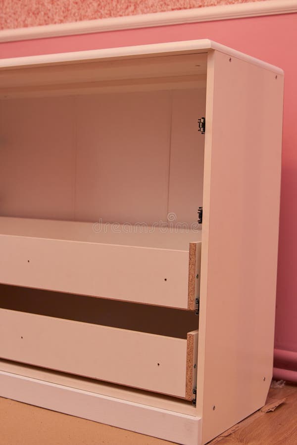 Assembling a Chest of Drawers, Assembling Furniture in the Room ...