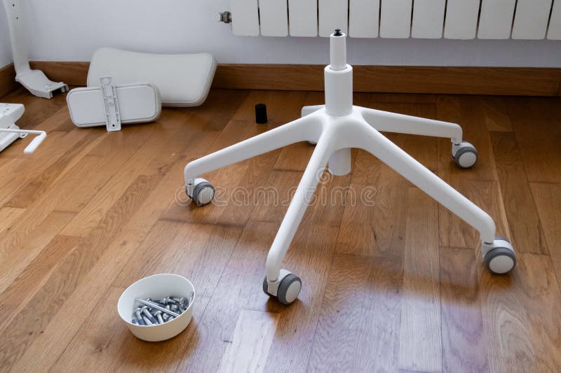 Assembling Office Chair Base with Wheels and Tools on Wooden Floor ...