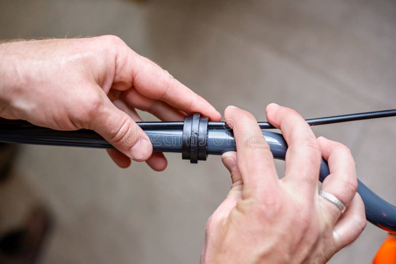 Assembling a Petrol Lawn Mower. a Man Attaches the Power Cable To the ...