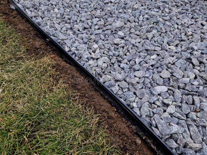 Assembly of Garden Curbs Made of Black Plastic. the Curb Separates ...
