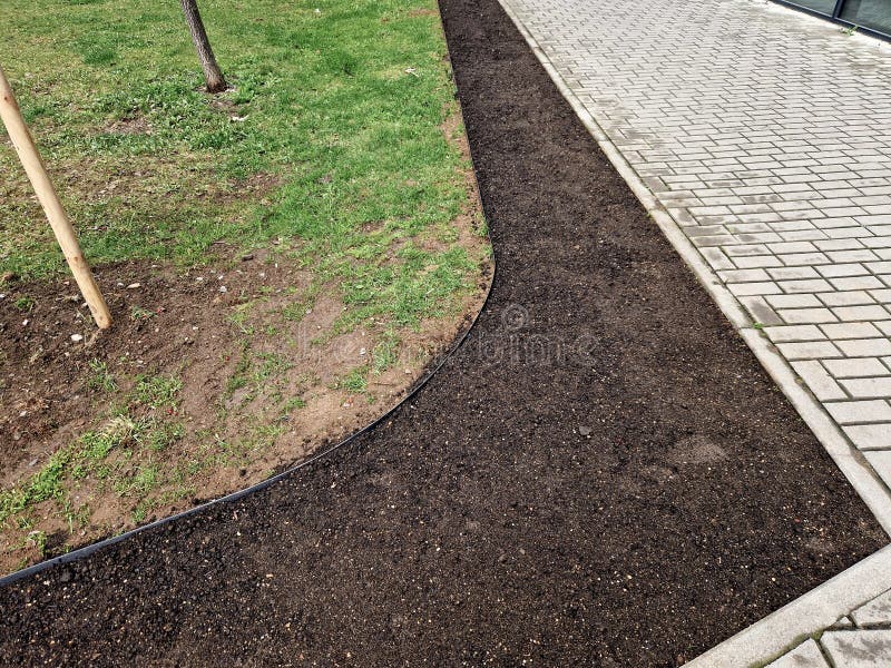 Assembly of Garden Curbs Made of Black Plastic. the Curb Separates ...