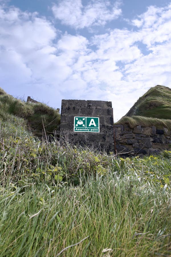Beach Assembly Point Sign on a Block Wall Stock Image - Image of notice ...