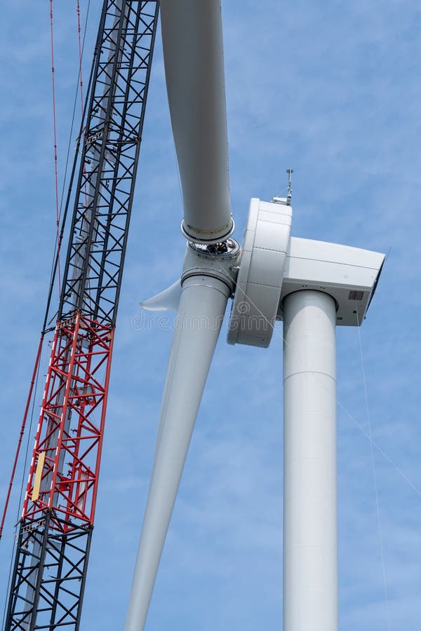 Assembly of a wind turbine stock photo. Image of installation - 392598680