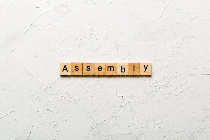 ASSEMBLY Word Written on Wood Block. ASSEMBLY Text on Cement Table for ...