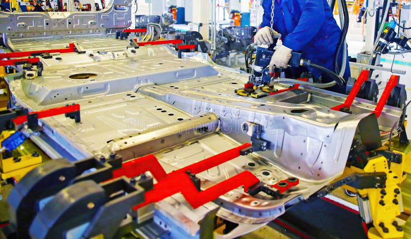 Assembly Workers are Constructing an Automotive Chassis at a ...