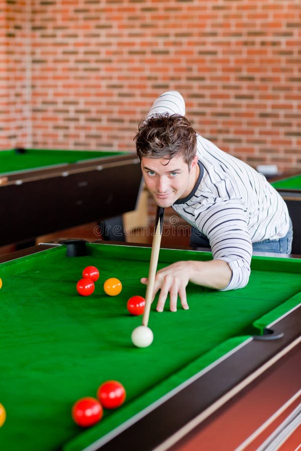 Young man playing pool. stock photo. Image of leisure - 2037224