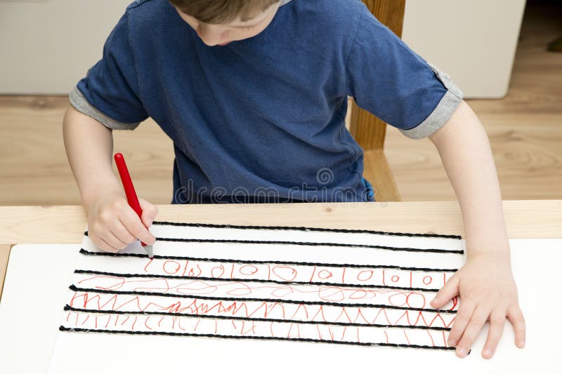 Child Learns To Write Symbols. Hand Training Tasks. Stock Photo - Image ...