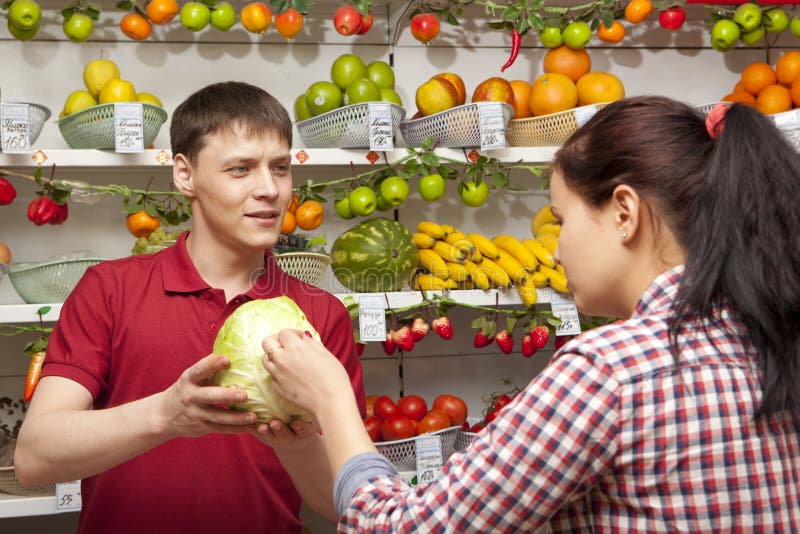 Assistant Helping Customer at Vegetable Counter of Shop Stock Photo ...