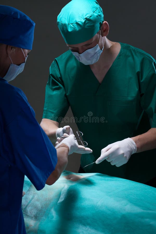 Assistant Helping Surgeon with Surgery Stock Photo - Image of ...