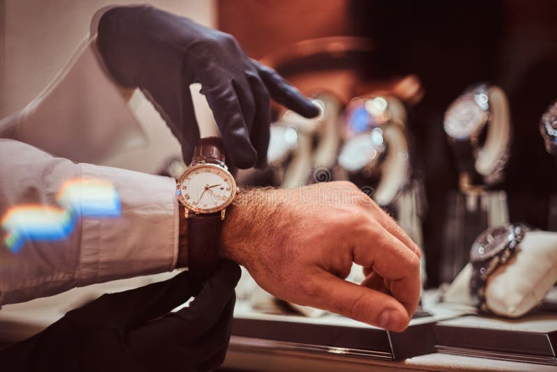 Close-up Hands. Assistant Helps the Client To Try on Exclusive Men`s ...