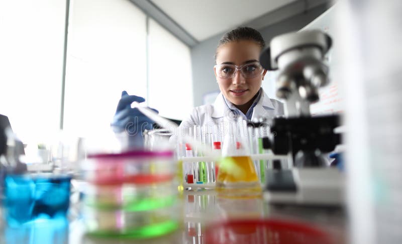 Assistant Pouring Liquid into Flask Stock Photo - Image of work ...